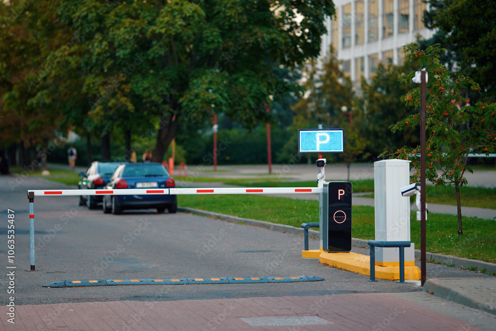 Automated barrier gate at parking lot entrance. Advanced automated boom ...