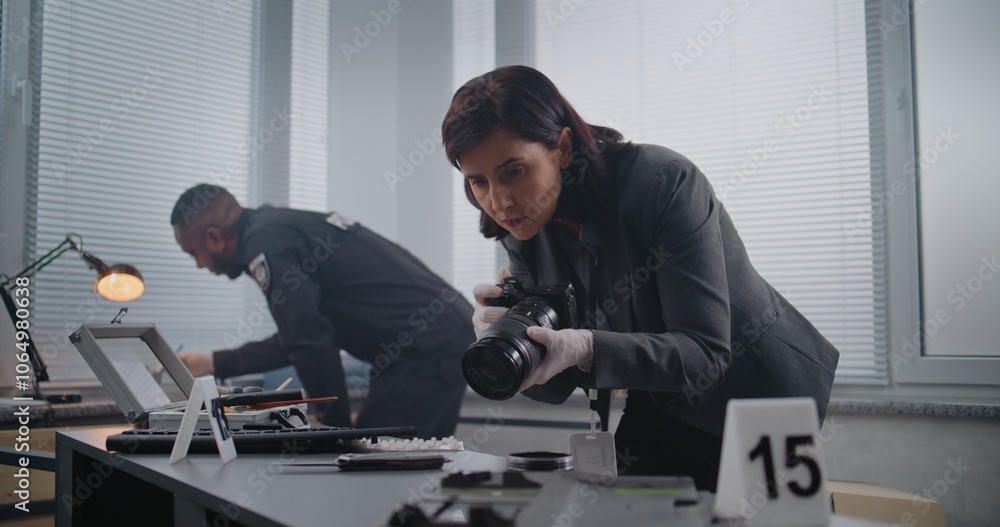Investigation team working at crime scene: Female criminalist takes ...