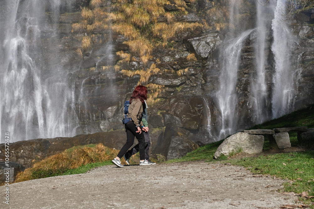 Tourists in hiking clothes holding hands near Cascate dell’Acquafraggia ...