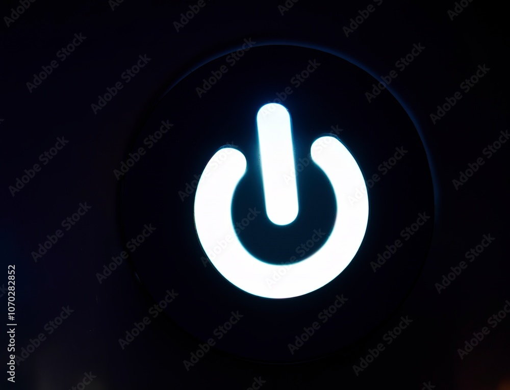 A brightly illuminated power button symbol, which is a white circle ...
