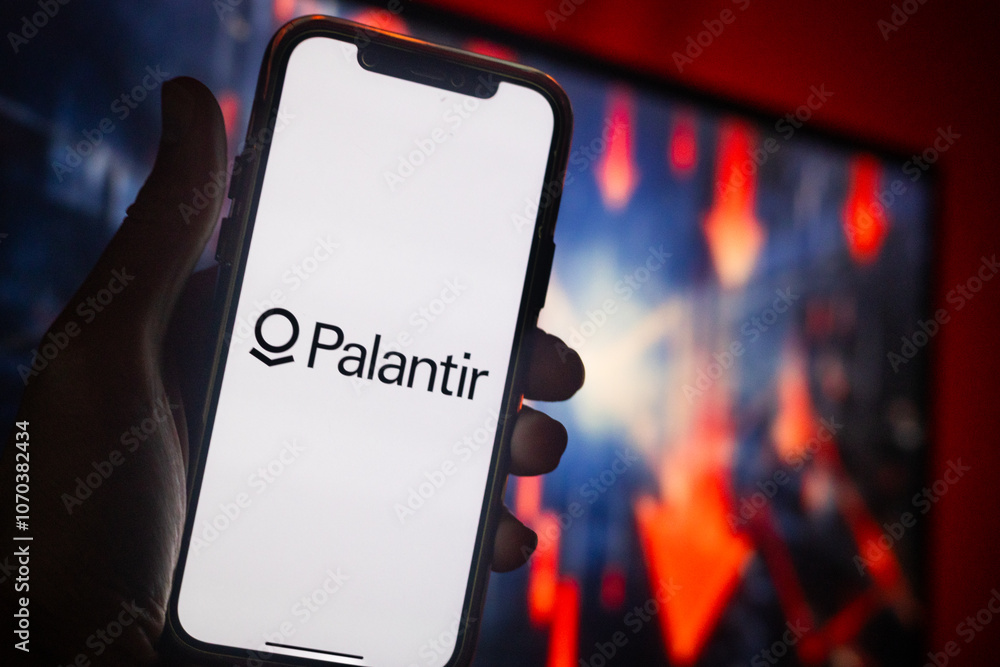Hand Holding Phone with Palantir (PLTR) Logo and Monitor in the ...