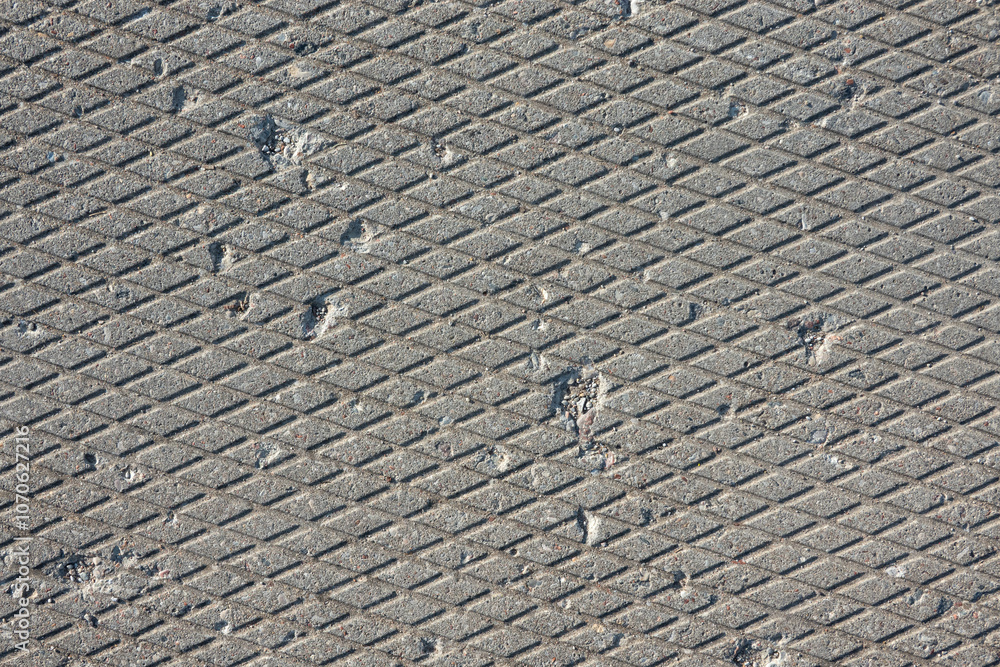Close-up of the surface of a grey concrete slab. There is a pattern of ...