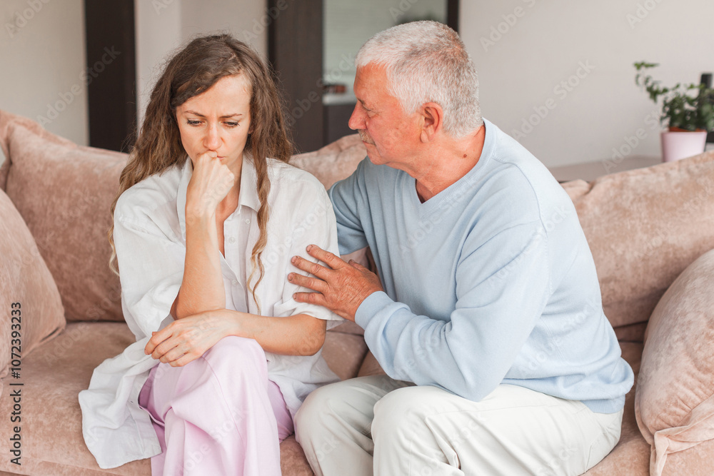 Worried aged father embracing comforting sad grown up daughter with ...