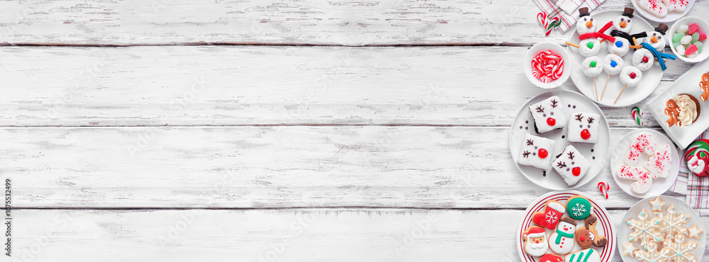 Cute Christmas desserts side border. Above view on a white wood banner ...
