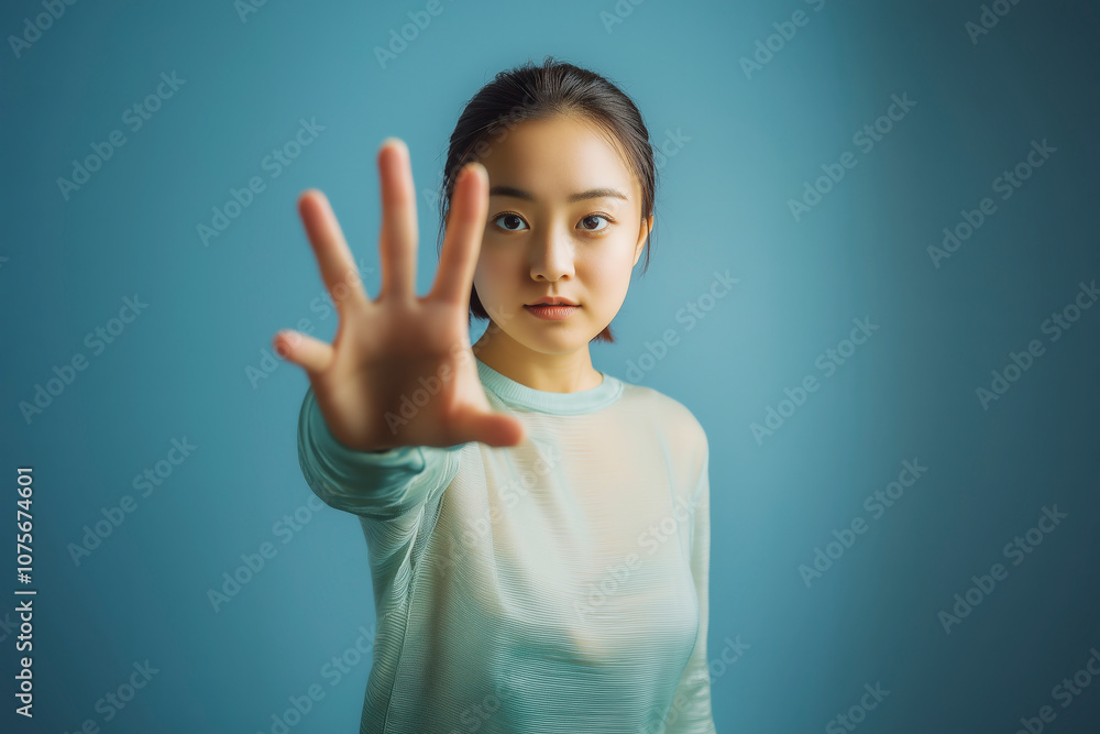 Woman holding her hand up, expressing resistance against authoritarian ...