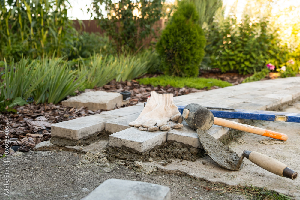 Laying paving stones on cement mortar. Laying a garden path made of ...