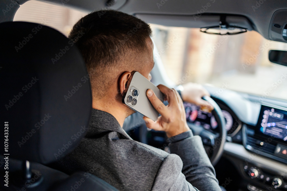 Foto de Stock Rear view of an elegant classy driver driving a car on a ...