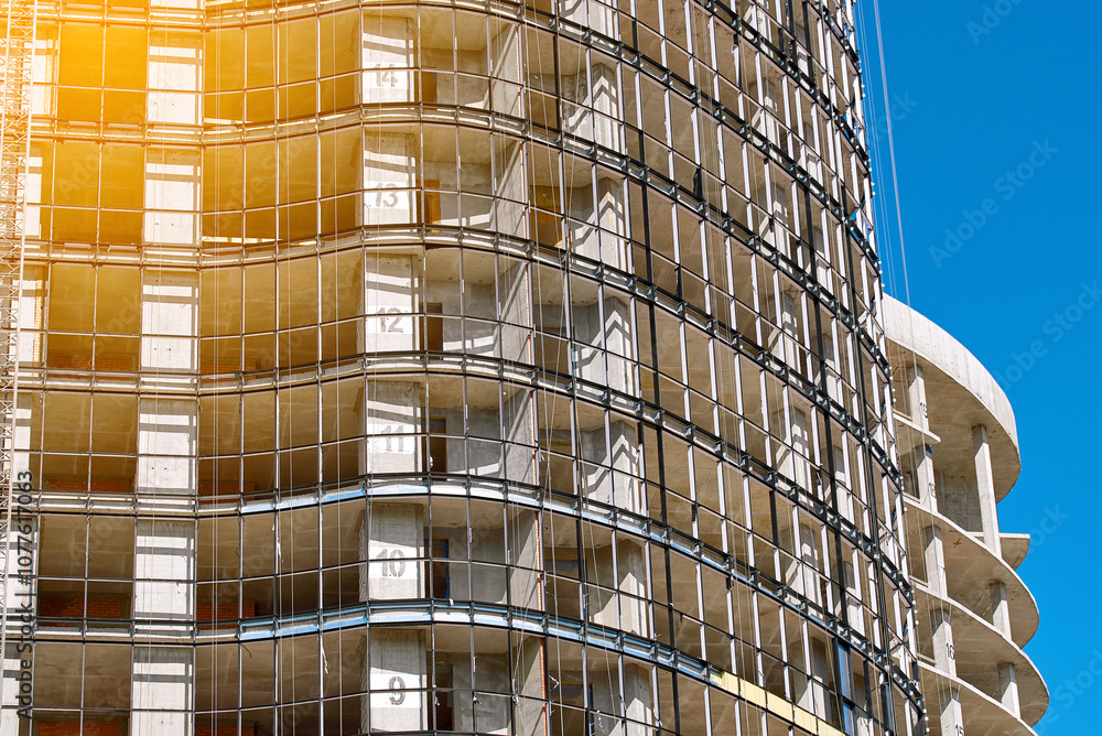 Insulation and Installation of glass curtain wall. Building under construction. Structural glass ...