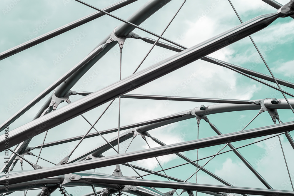 Metal structures with mesh and cables under a blue sky, forming an ...
