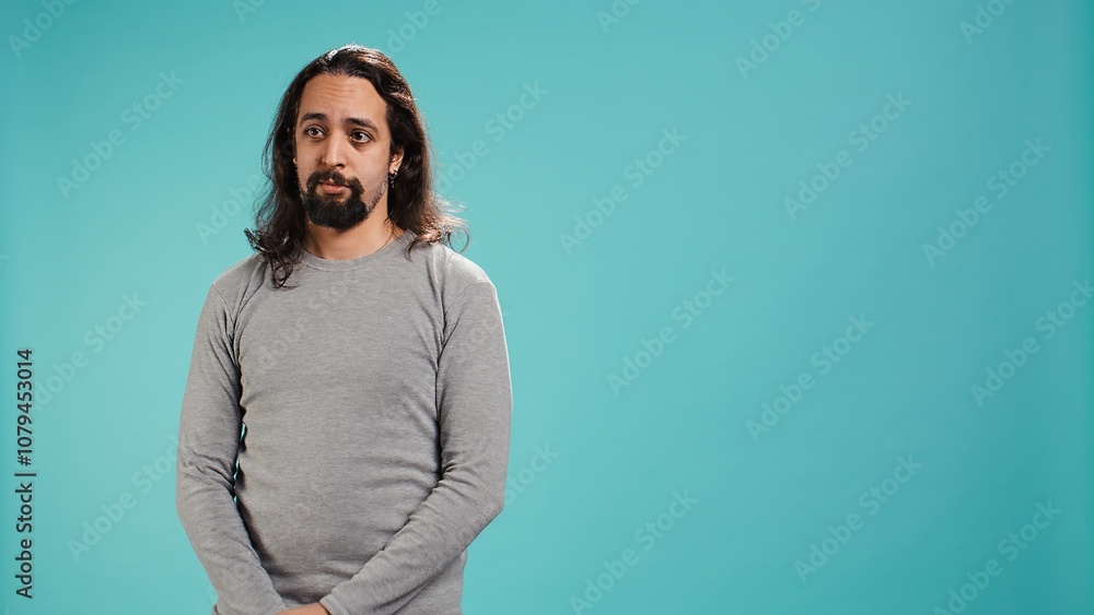 Portrait of spiteful man making exaggerated silly faces, mimicking ...