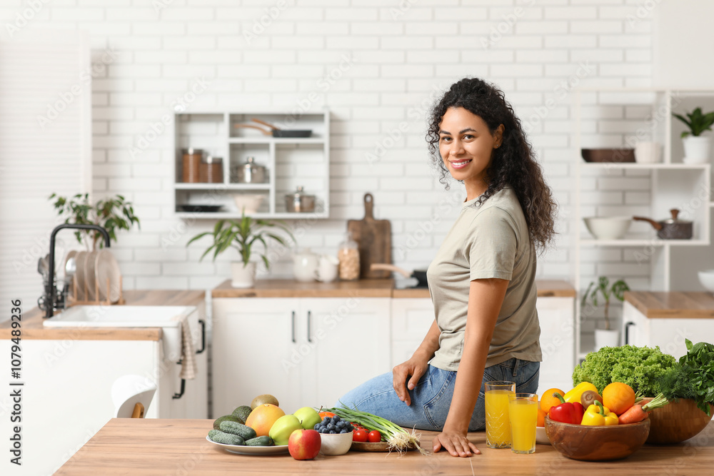 Young happy African-American woman with glasses of juice, different ...