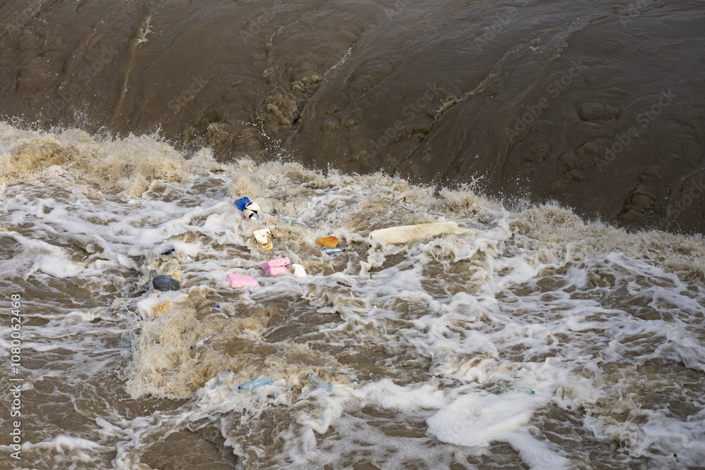 Floating garbage and debris swept by powerful river currents after ...