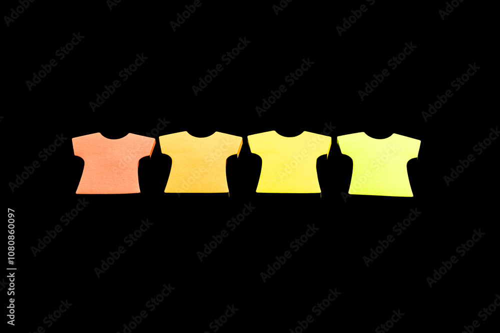 Four blank sticky note pads in the shape of T-shirts, arranged in a row ...