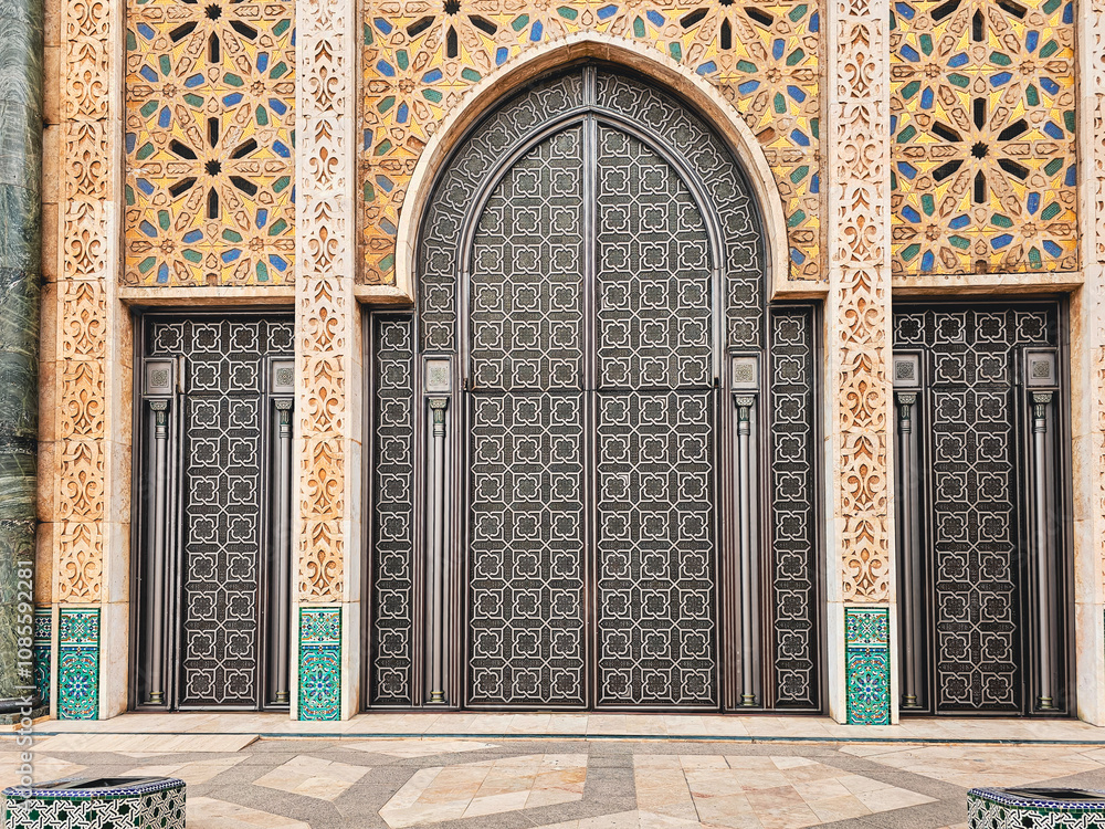 view of Hassan II mosque's big gate full of beautiful moroccan mosaic ...
