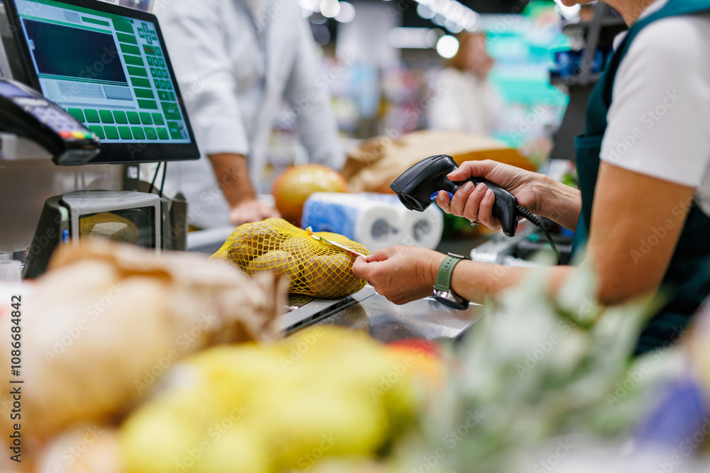 Cashier scanning potatoes at supermarket checkout counter Stock Photo ...