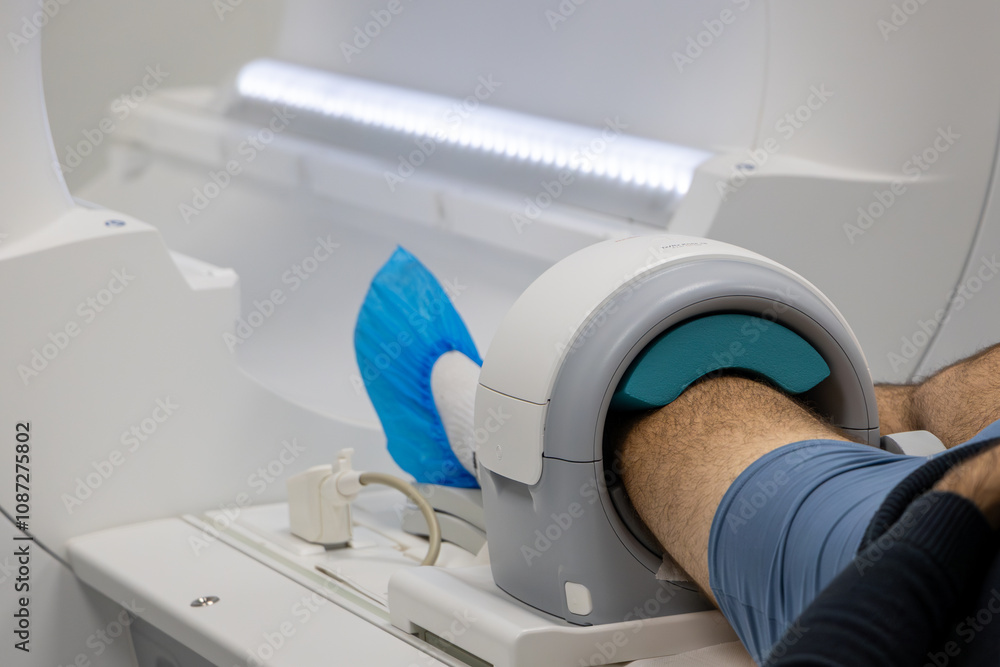 Knee MRI scan examination at clinic. Prepares the patient for an MRI ...
