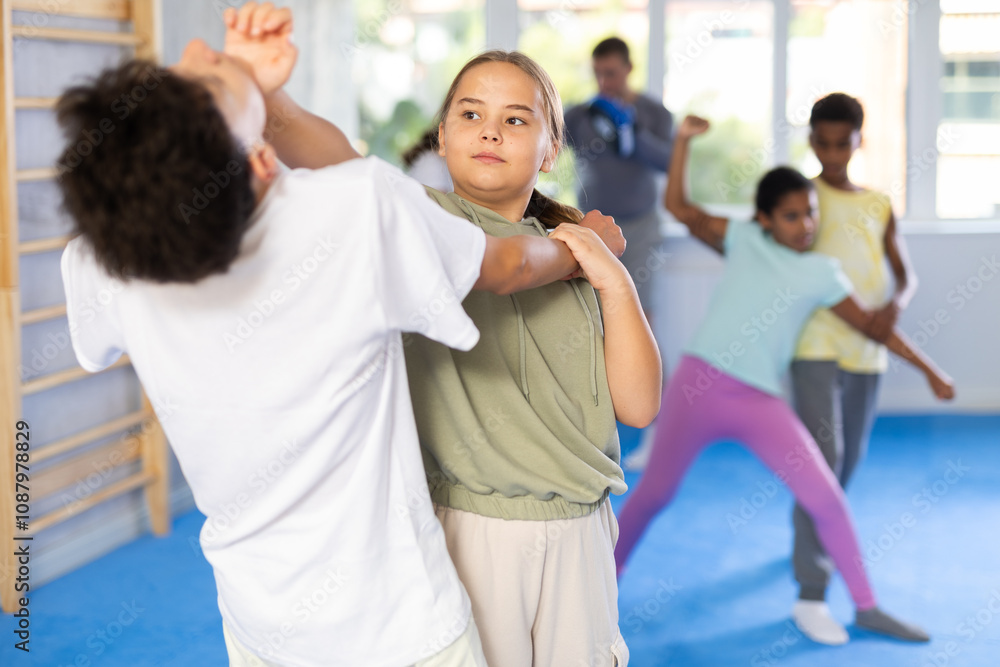 Stock-Foto „Concentrated tween girl practicing effective self-defense ...