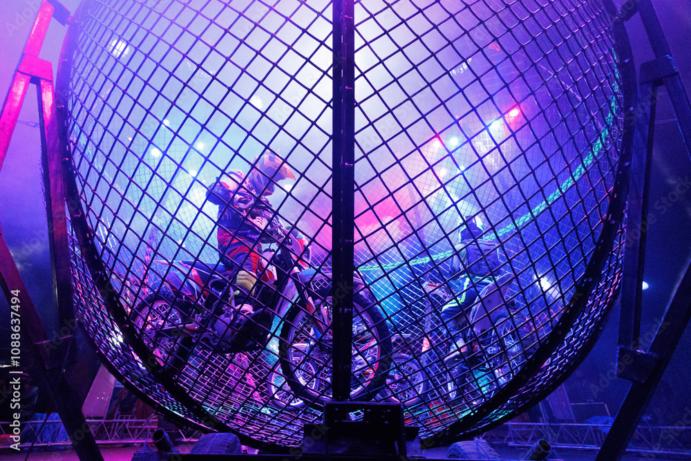 Dangerous show involving motorcyclists in circus. Stuntmen ride ...