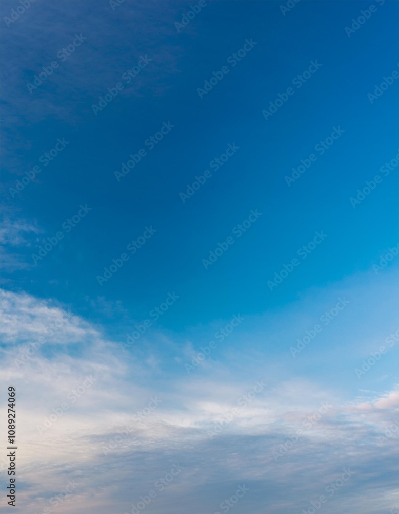 High-resolution image of a serene sky with soft fluffy clouds lit by ...