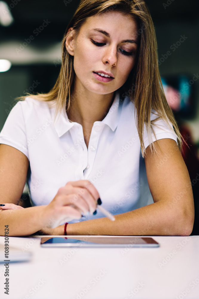 Thoughtful female designer using modern digital tablet for drawing ...