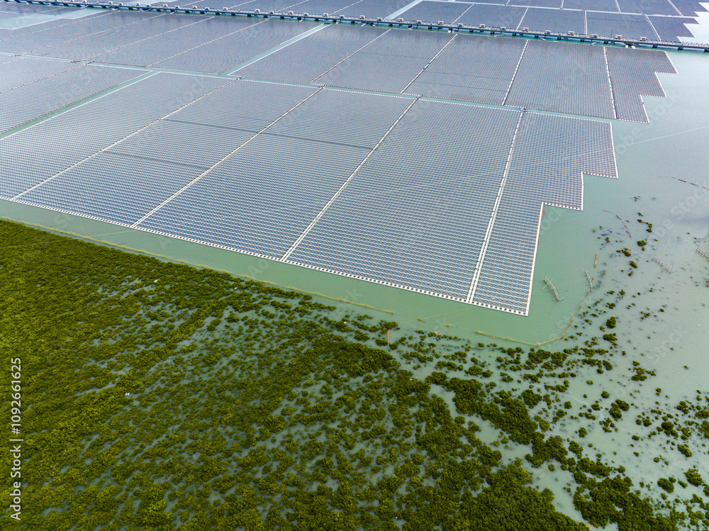 Water marked solar panels float on a water surface, capturing sunlight to generate clean energy ...