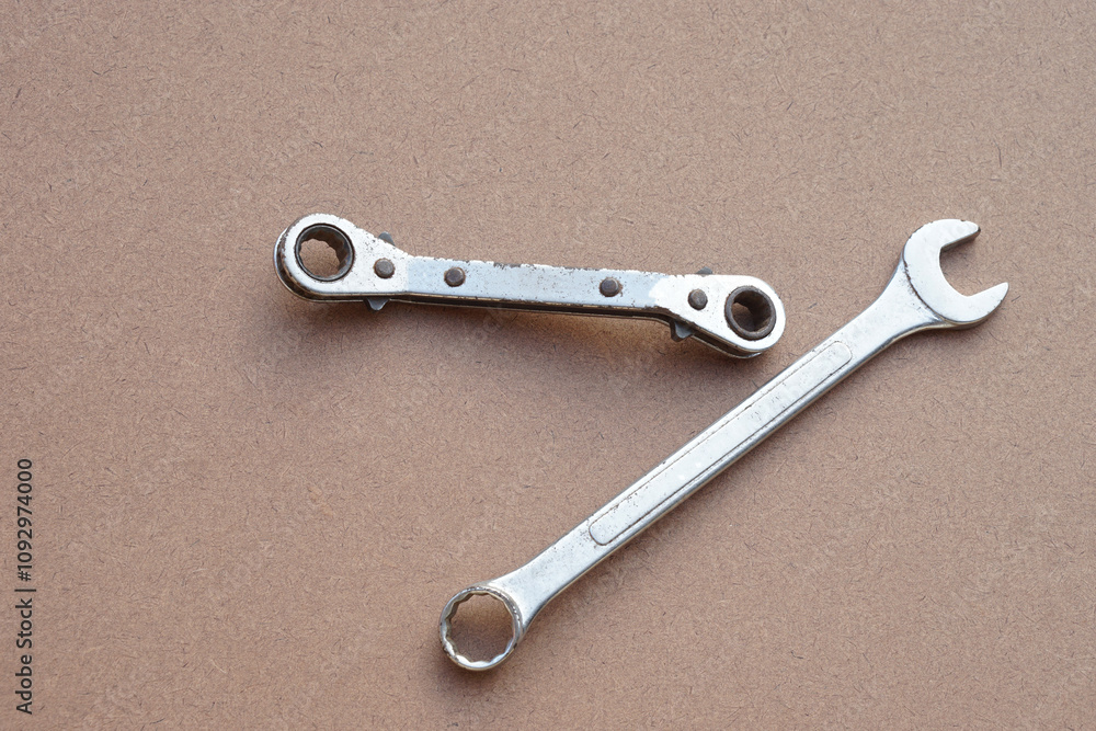 Metal chrome wrenches or spanners on brown background. Concept ...