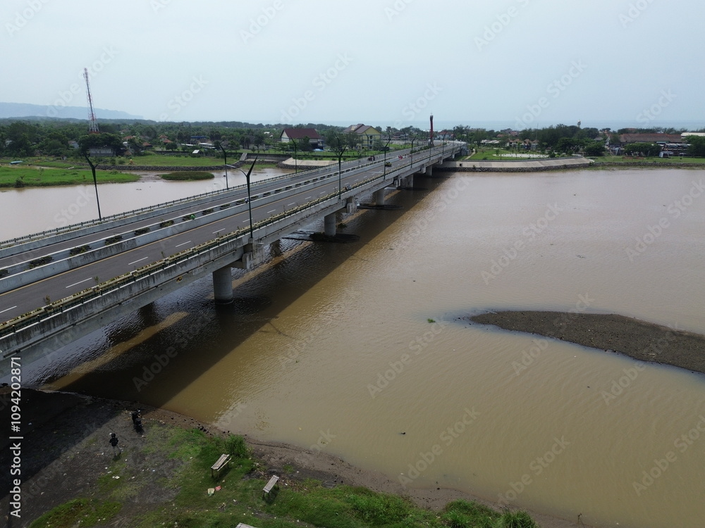 Aerial photograph showing a highway bridge spanning a wide river ...