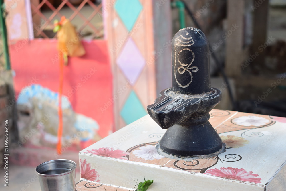 Shiva Linga statue, Small black Shivling statue on a rock, The icon of ...
