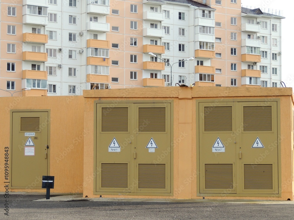distribution transformer booth with several doors with signs about the ...