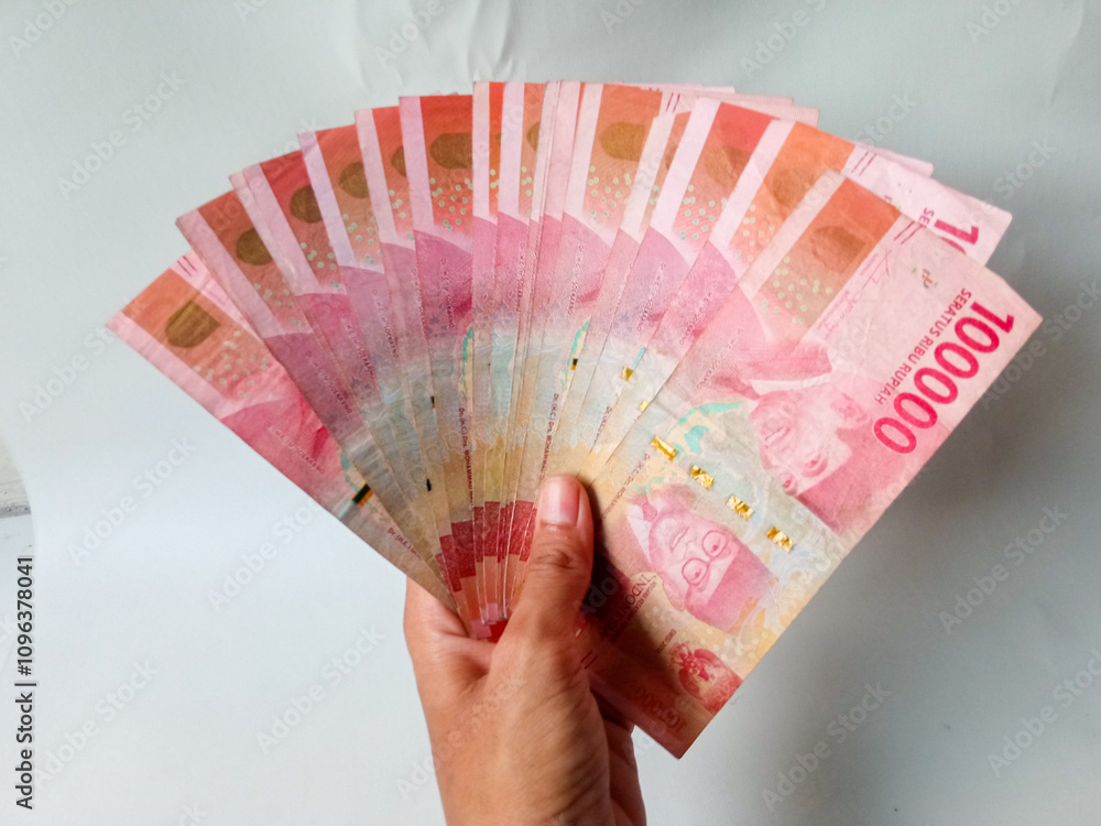 Cash payment concept. Indonesian rupiah currency (Rp. 100.000 Seratus Ribu Rupiah), One hundred ...