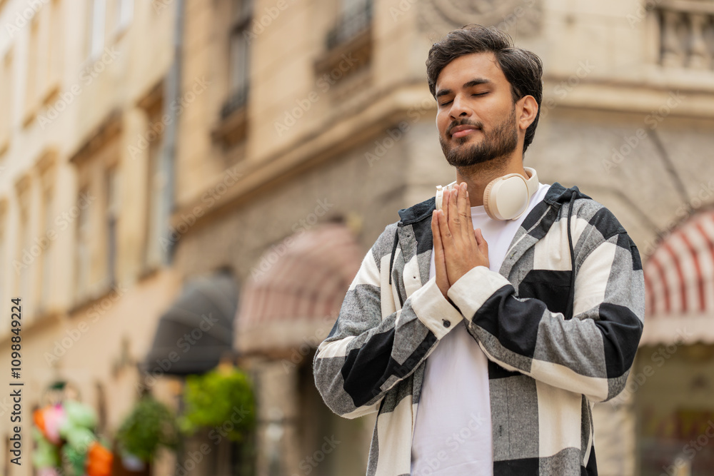 Religious Indian man tourist praying with closed eyes to God asking for ...