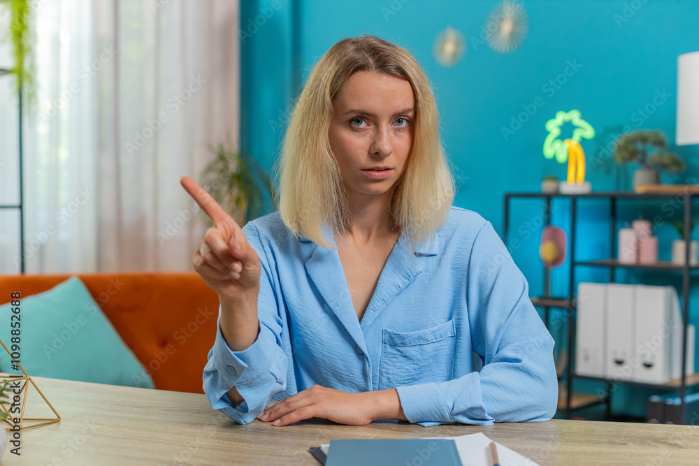 Portrait of Caucasian young business woman shakes finger, saying No be ...