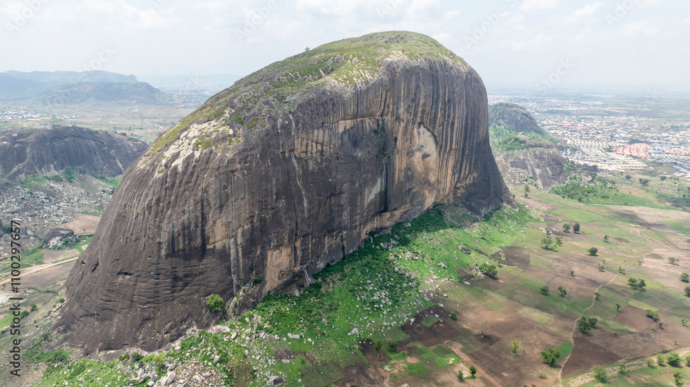 Aerial view of zuma rock surrounded by expansive greenery and a ...