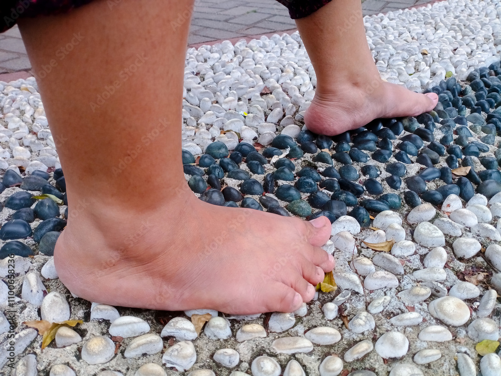 Bare feet asian woman walking on stepping stones for health ...