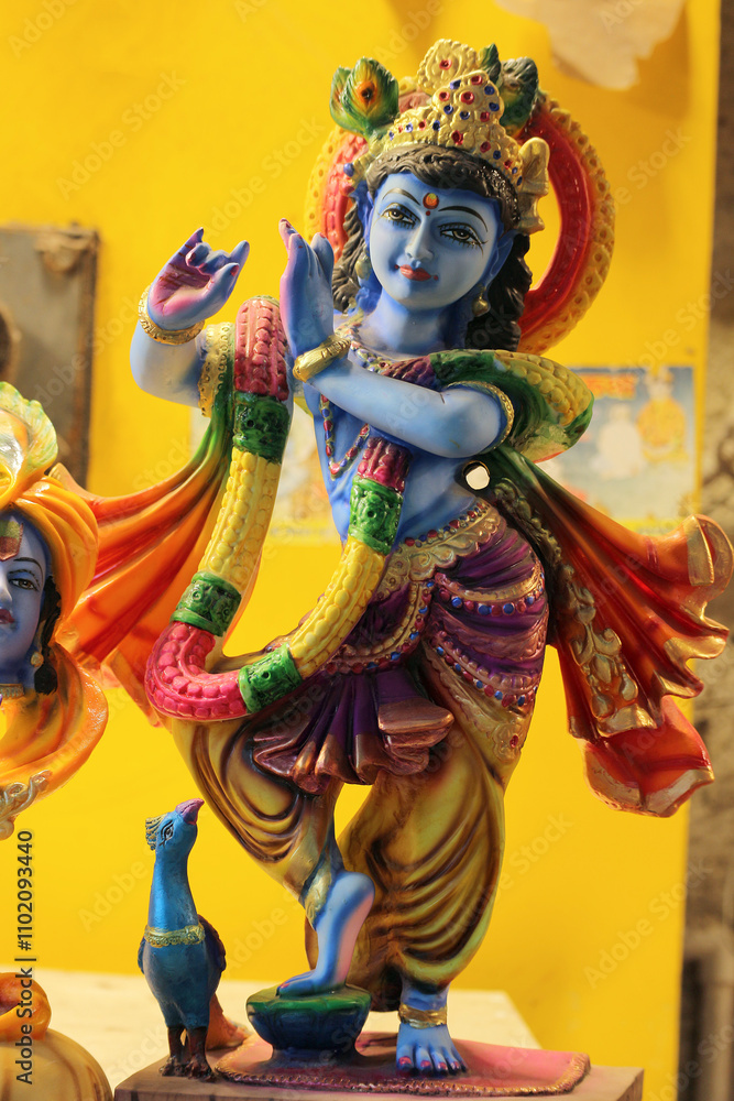 Hindu god Krishna on yellow background. Religious figurine in India ...