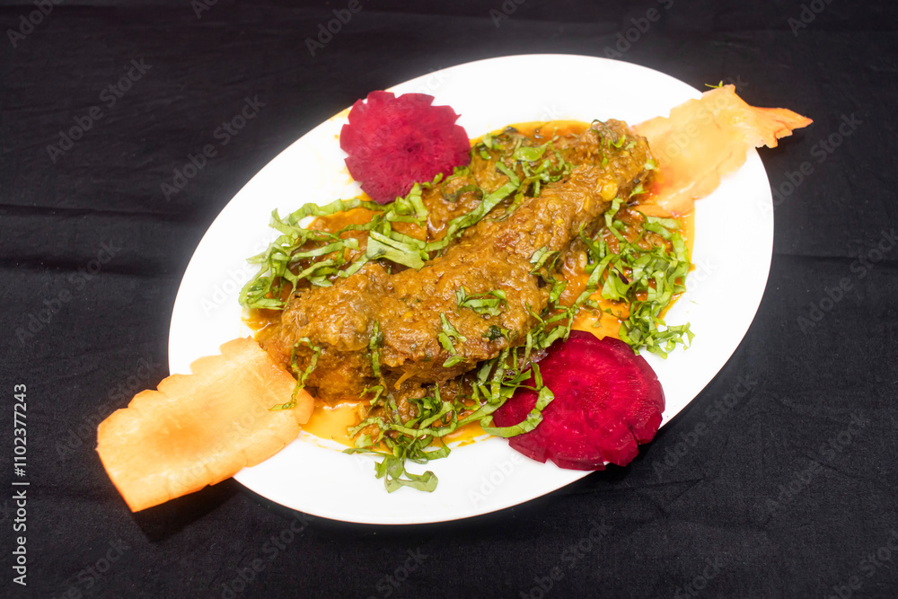 rohu fish curry topping with coriander served in tray dish isolated on ...
