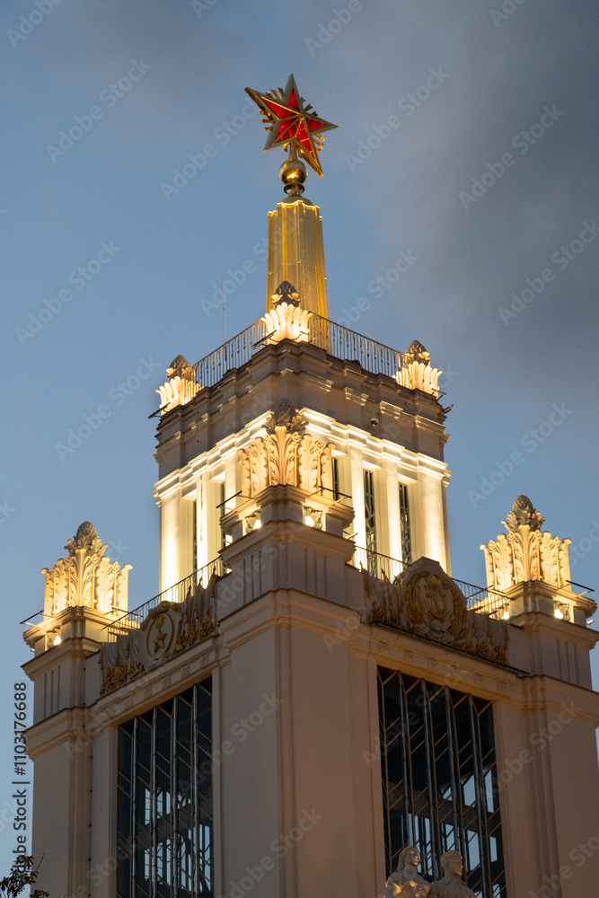 Evening photo of the Soviet star symbol atop a pavilion at VDNH ...
