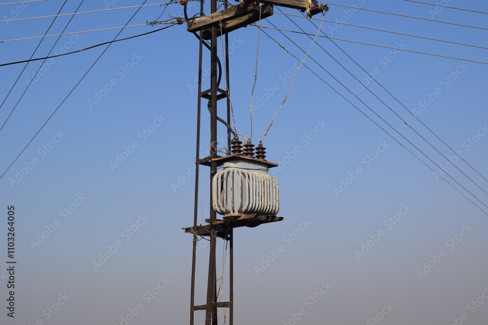 portrait of an electric substation with its cables stretching against a ...