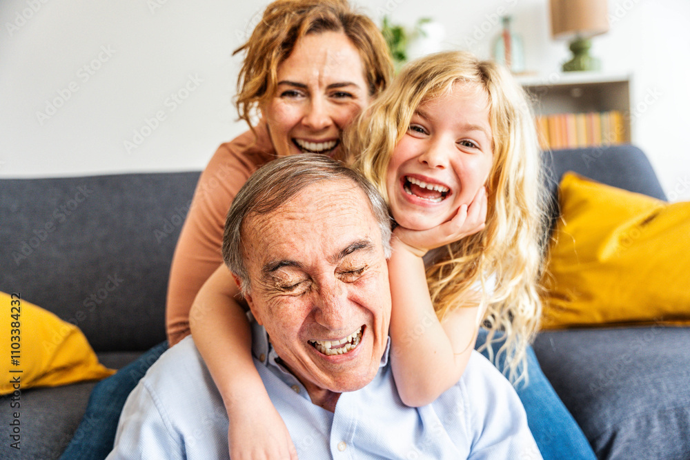Happy multi-generational family smiling at camera together ...