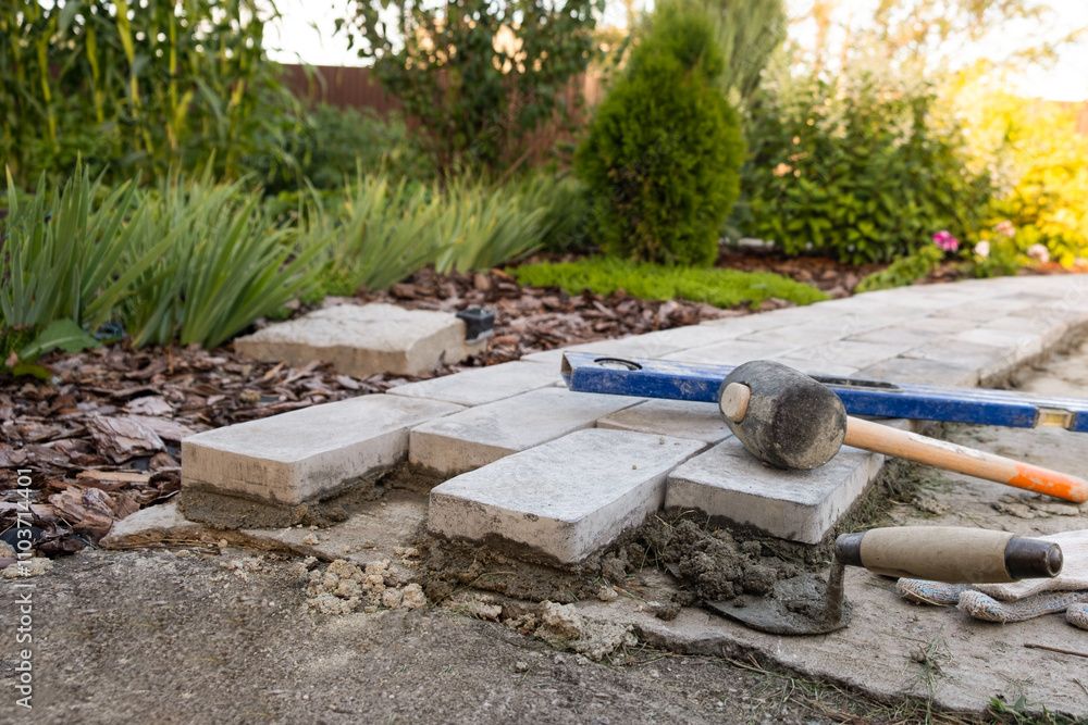 Laying paving stones on cement mortar. Laying a garden path made of ...