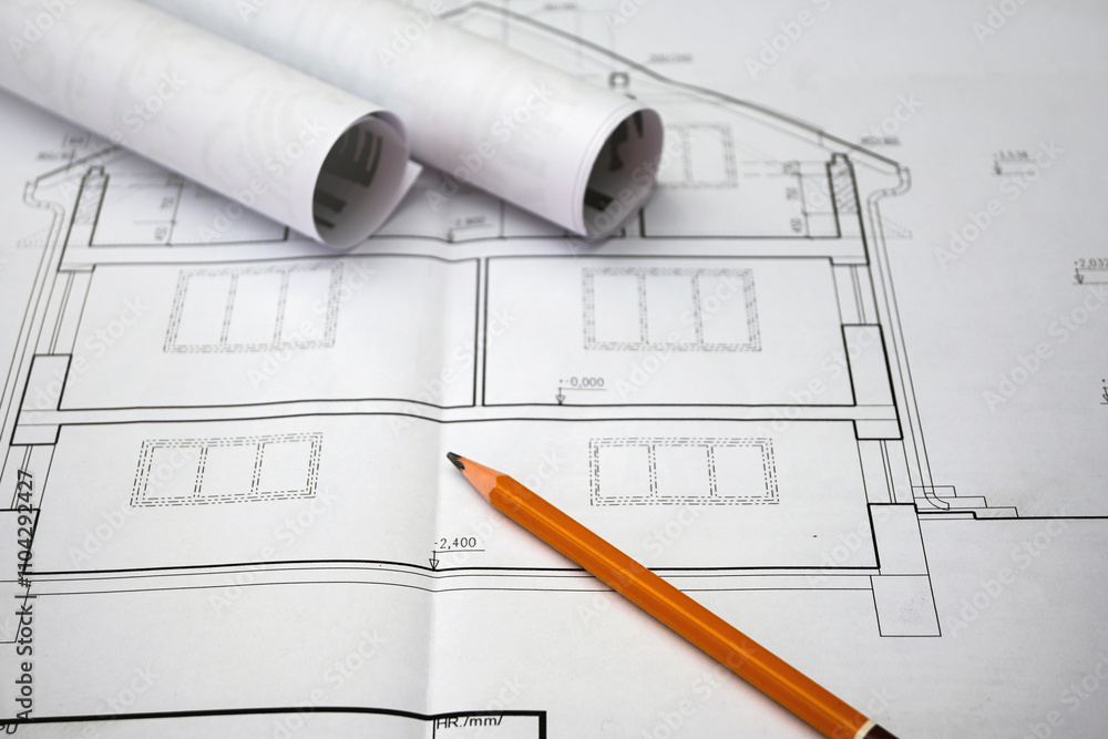 Architectural drawings displaying house plans, accompanied by a pencil ...