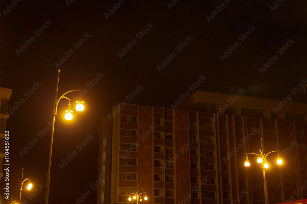 The urban landscape showcases stunning streetlights along the road and ...