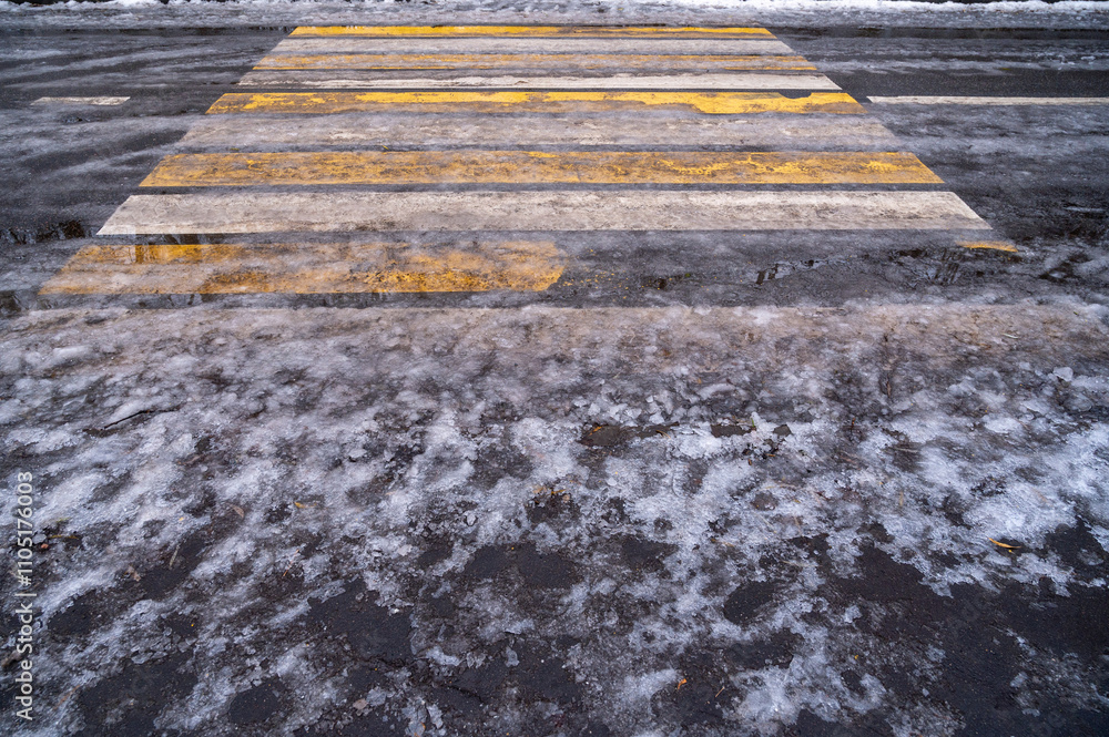 Cross walk empty covered with ice and snow. Pedestrian crossing ...