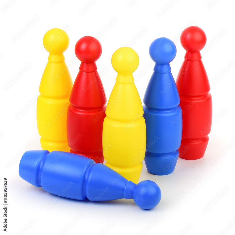 Multi colored bowling pins and a bowling ball isolated on a white background. Children's plastic ...