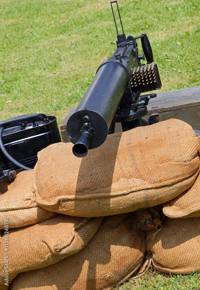 Sandbags of a trench with the historical black water-cooled machine gun ...