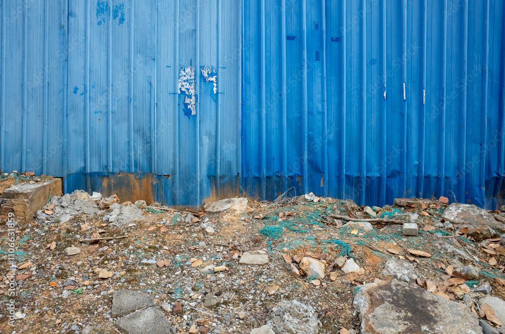 Weathered blue corrugated metal wall with rust and peeling paint ...