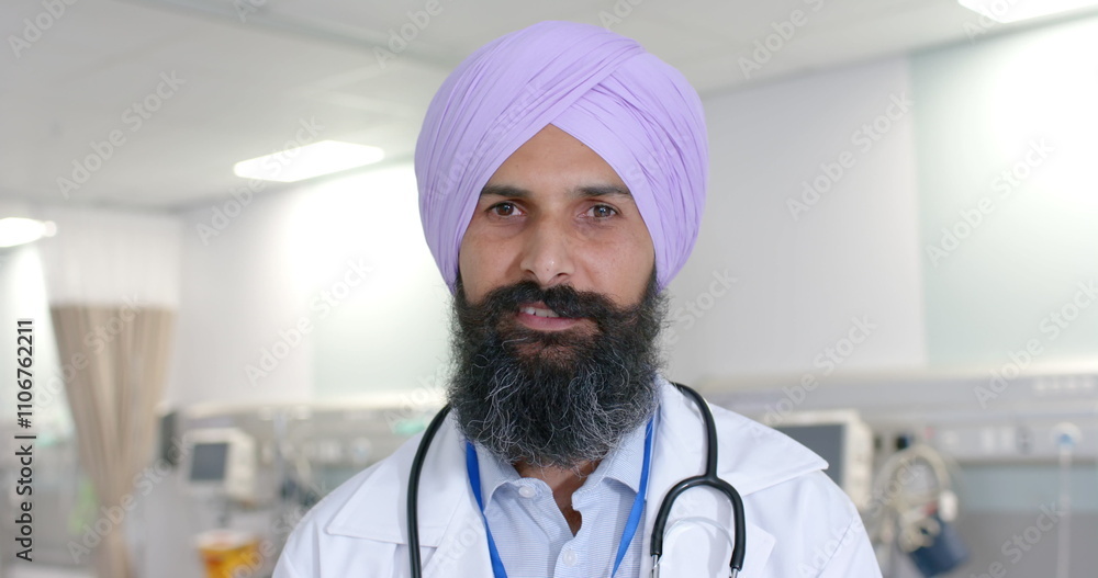Portrait of happy biracial sikh male doctor in turban looking at camera ...