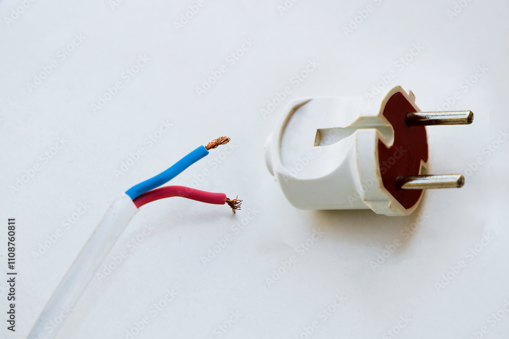 Broken electrical wire with a plug isolated on a white background ...