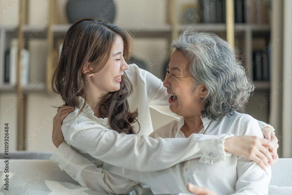 portrait of bonding senior mother and adult daughter,old woman sitting on couch,a young female ...