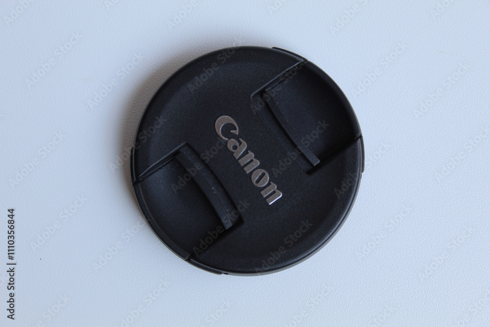 Semarang, Indonesia - January 1st 2024: A lens cover or lens cap of Canon, isolated on white ...